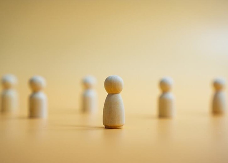 Standing Out From the Crowd and Leadership Concept with Wooden Figurines